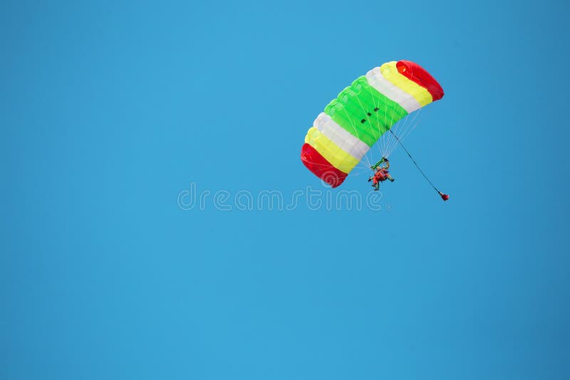 Two People on a Multi-colored Parachute in the Sky Stock Photo - Image ...