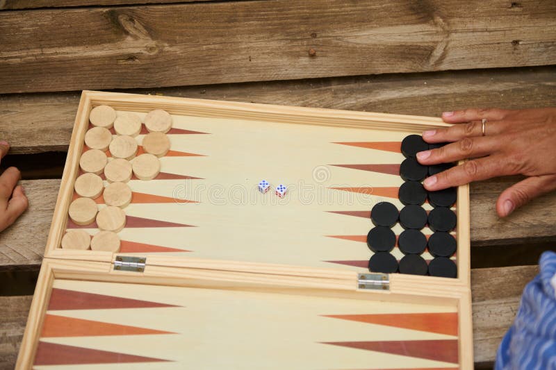 Two People Playing a Game of Backgammon with Wooden Board and Dice ...