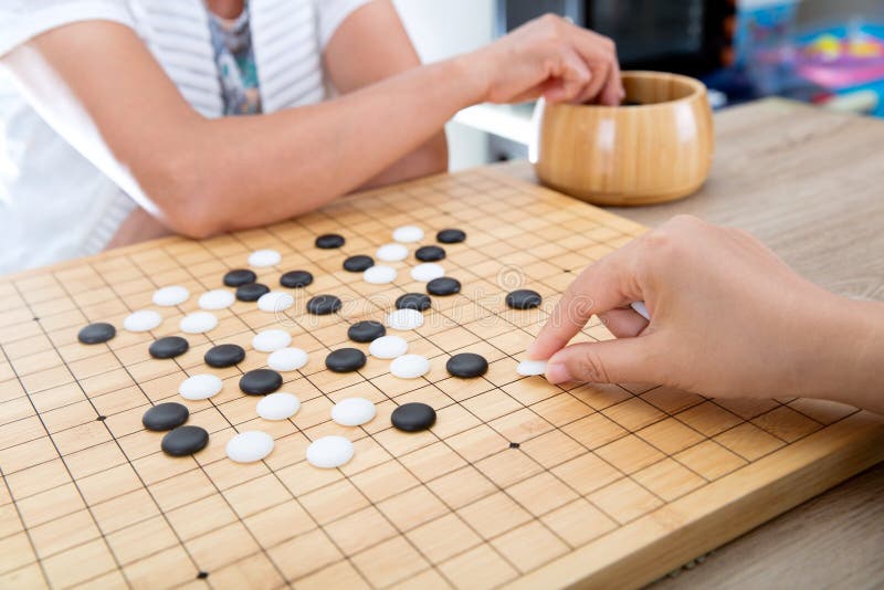 Chinese Go Game on table stock photo. Image of black - 228924396