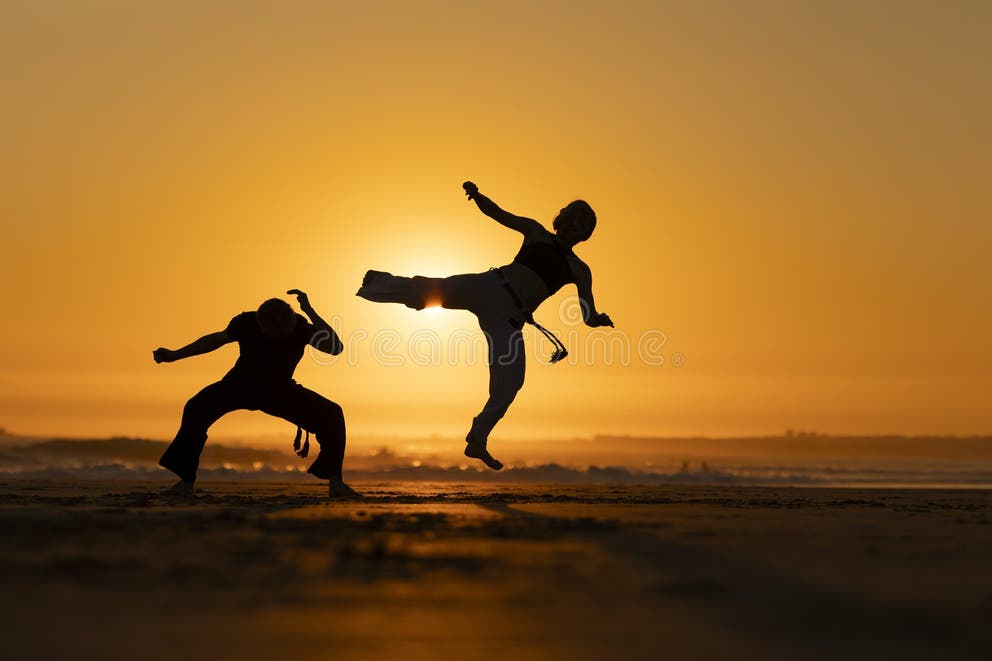 Two People are Practicing Karate on a Beach at Sunset Stock Photo ...