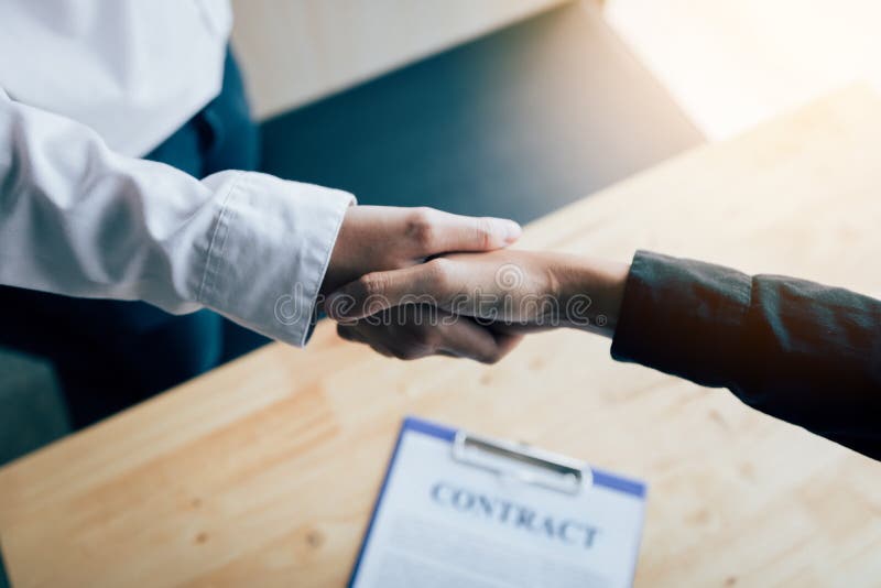 Two People Shaking Hands with Making a Contract in the Office. Stock ...