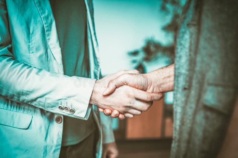 Two People Shaking Hands in a Room Stock Photo - Image of partnership ...