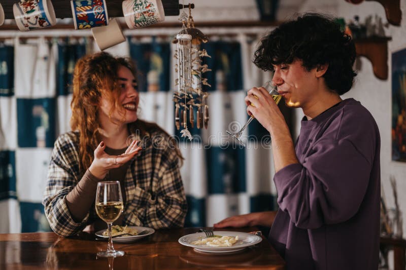 Two Friends Enjoying Dinner and Drinks at a Warm and Cozy Indoor Space ...