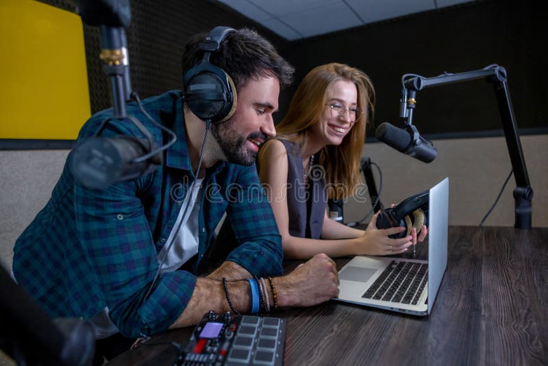 Two People Sitting at the Table and Watching Something on Laptop Stock ...
