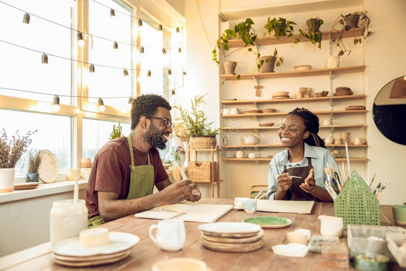 Two People Sitting at the Table and Working with Pottery Stock Image ...