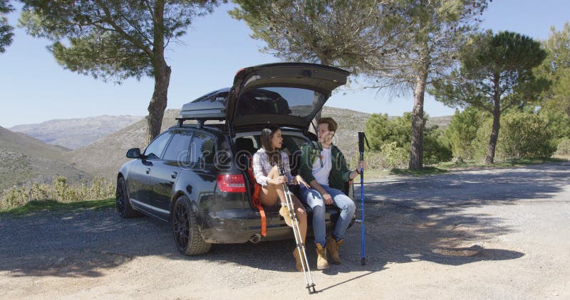 Two People Sitting in Trunk in Mountains Stock Image - Image of tourist ... Two People Sitting in Trunk in Mountains Stock Image - Image of tourist ...