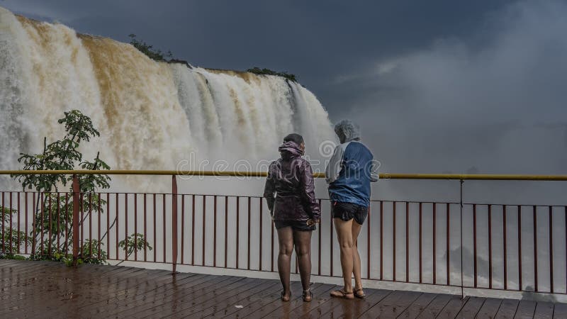 Two People are Standing on the Observation Deck at the Waterfall ...