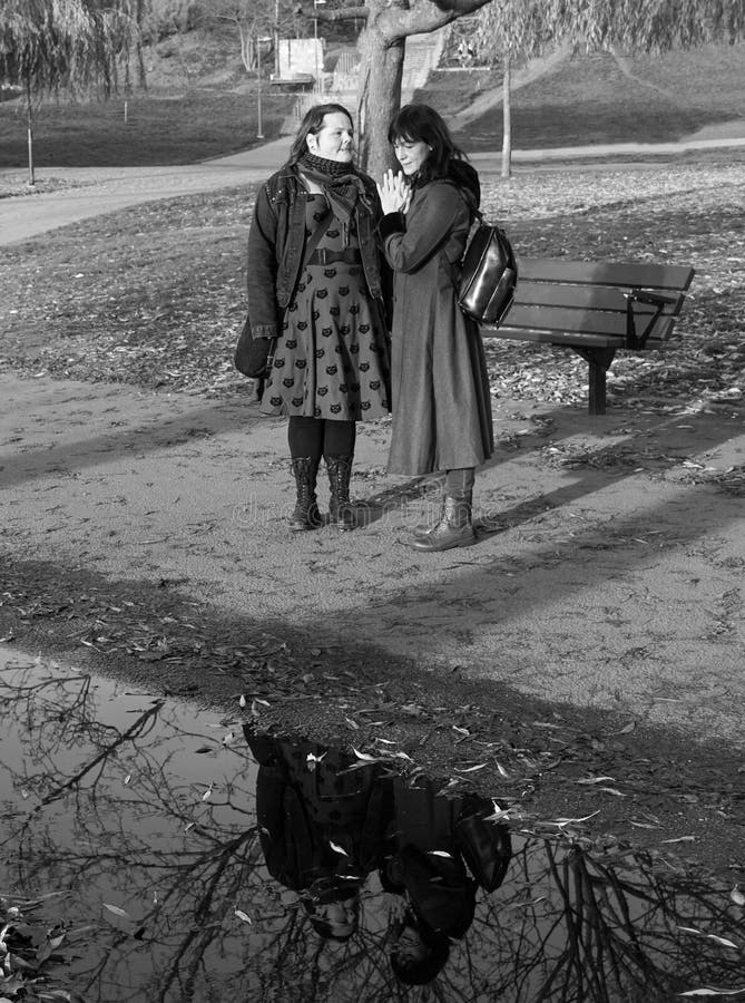 Two People Standing on a Road Stock Photo - Image of monochrome, shades ...