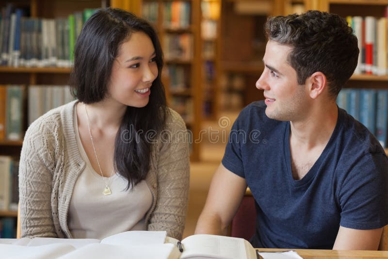 Two People Studying in a Library Stock Image - Image of speaking, shelf ...