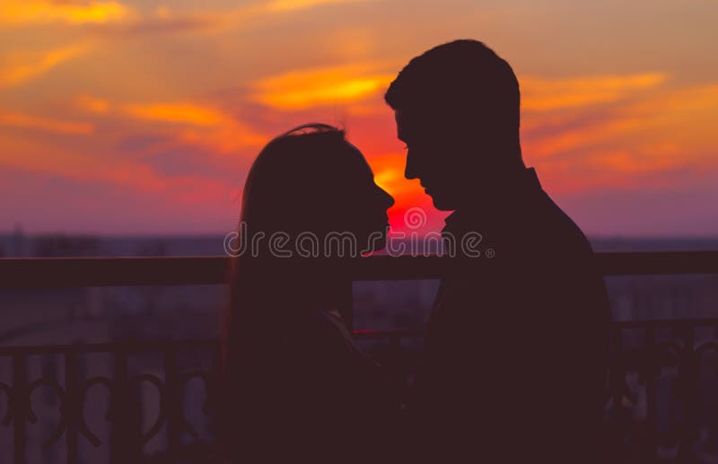 Two people sunset stock photo. Image of calm, sunset - 80761120