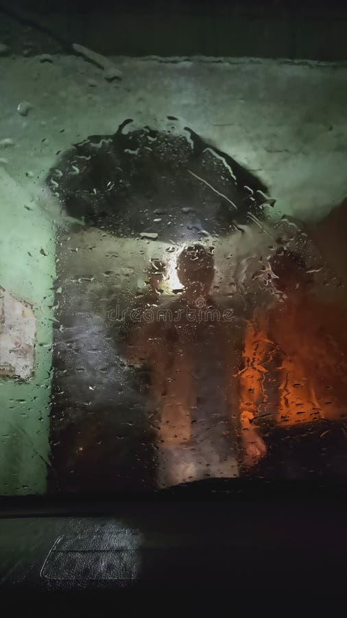 Two People with Umbrella in the Rain through Car Window at Night. Stock ...