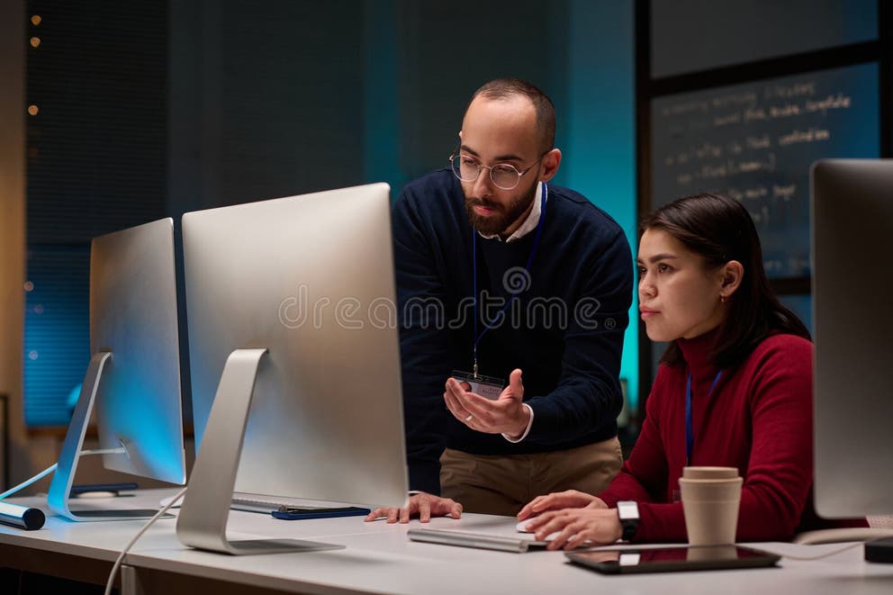 Two People Using Computers and Coding with Blue Lights Stock Image ...
