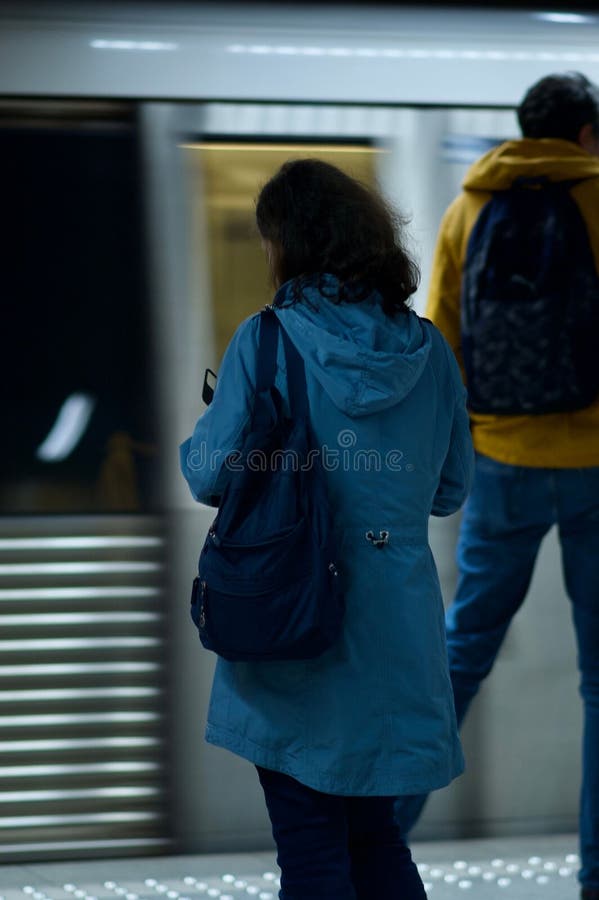 Two People Wait on the Platform To Board a Subway Train Stock Photo ...