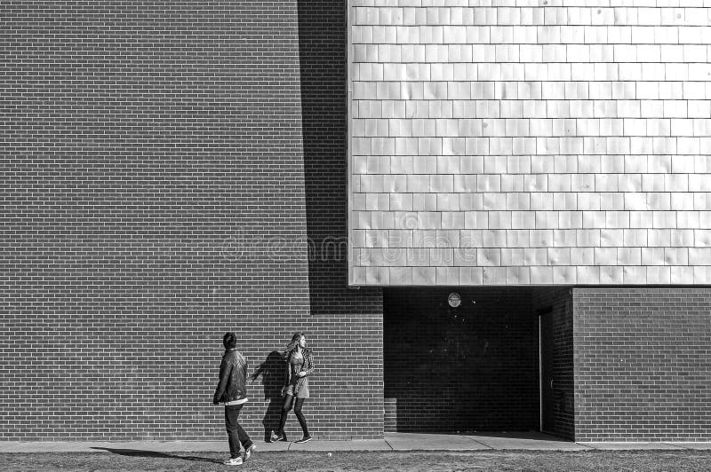 Two People Walk in Front of a Modern Building Editorial Photo - Image ...