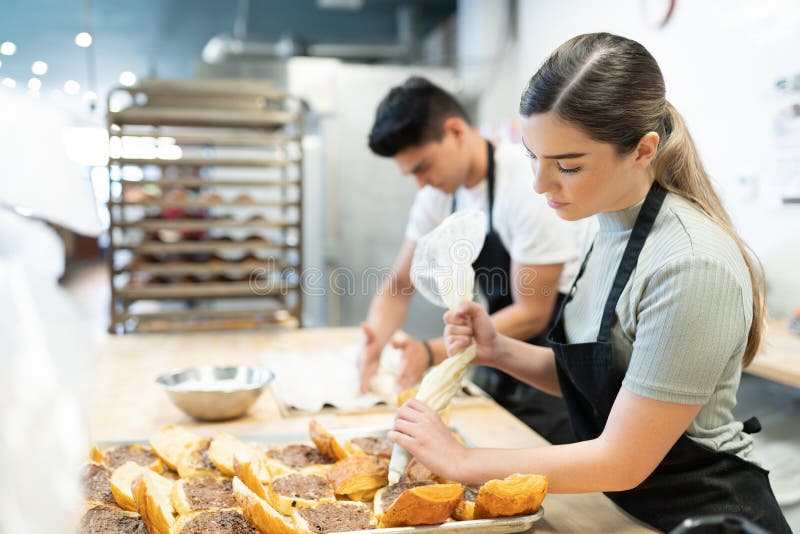 Two People Working in a Bakery Stock Image - Image of cream, female ...