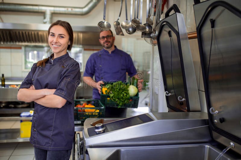 Two People Working in the Kitchen and Washing Veggies Stock Image ...