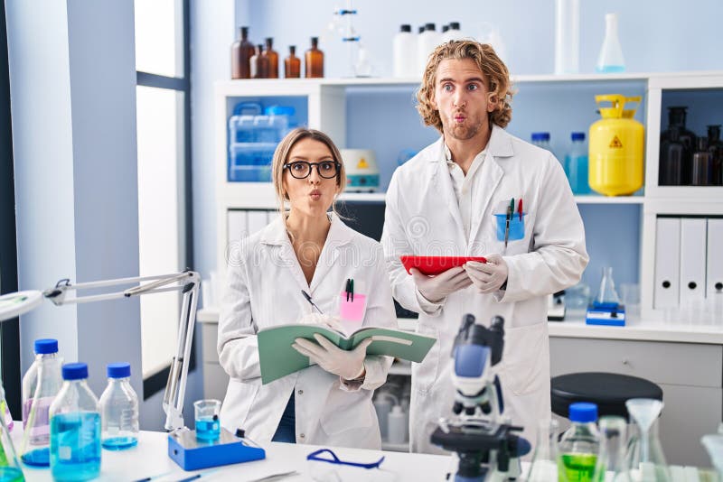 Two People Working at Scientist Laboratory Making Fish Face with Mouth ...