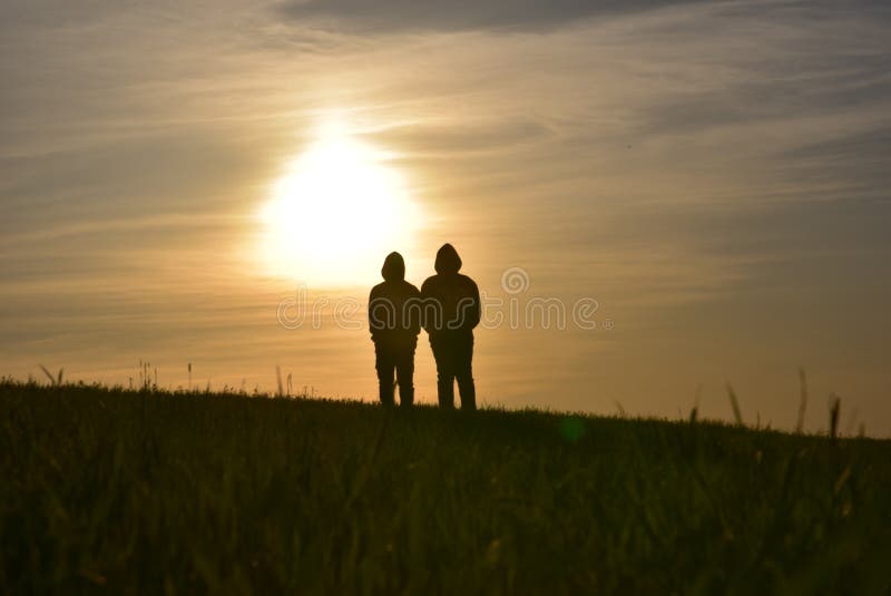 Two Person in Front of the Sunset Stock Image - Image of grass, person ...