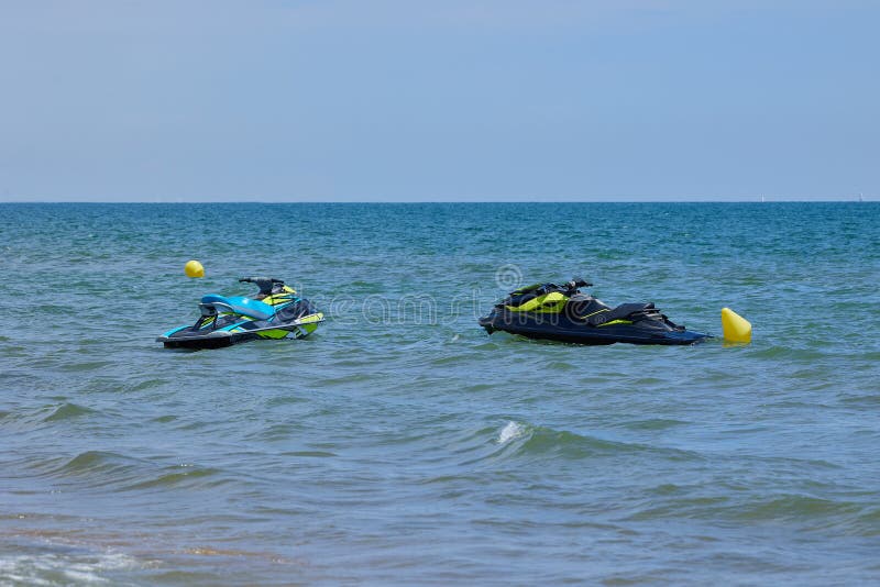 Two Personal Watercraft Waiting for Riders in Front of the Beach Stock ...