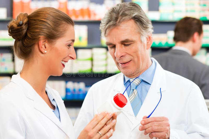 Two Pharmacists in Pharmacy Consulting Stock Image - Image of ...