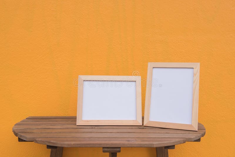 Two Photo Frame on a Wooden on Yellow Background . Stock Photo - Image ...