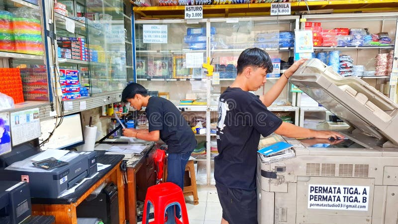 Two Photocopy Workers are Working in a Busy Shop Atmosphere. Editorial ...