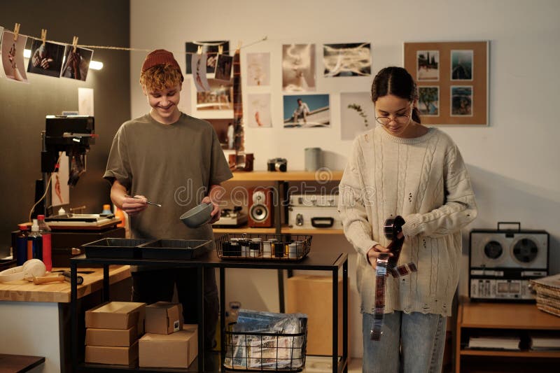 Two Photographers Collaborating in Studio Developing Photo Film Stock ...