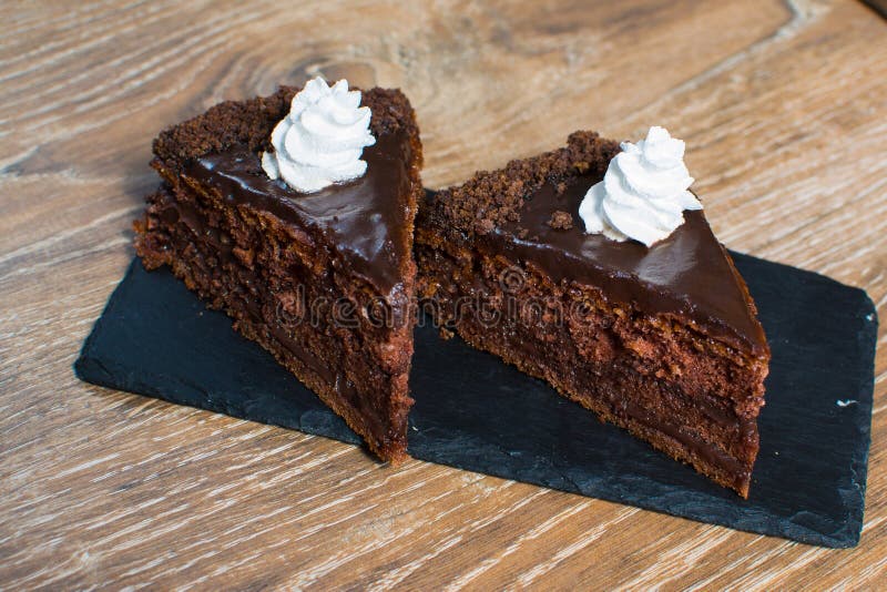 Two Pieces of Cake on a Stone Plate Stock Image - Image of slice, table ...