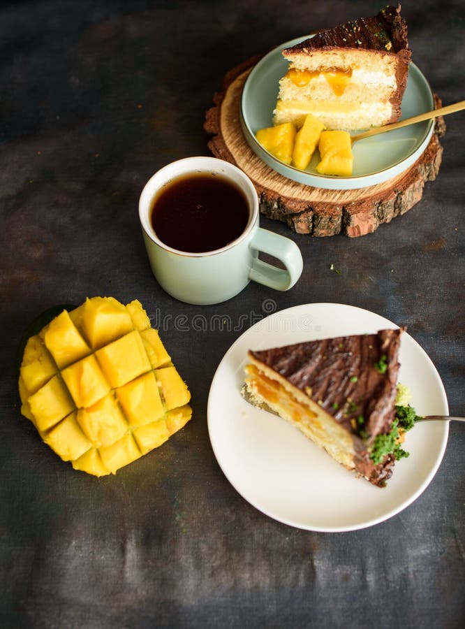 Two Pieces of Delicious Cake with Mango, a Cup of Fragrant Tea. View ...