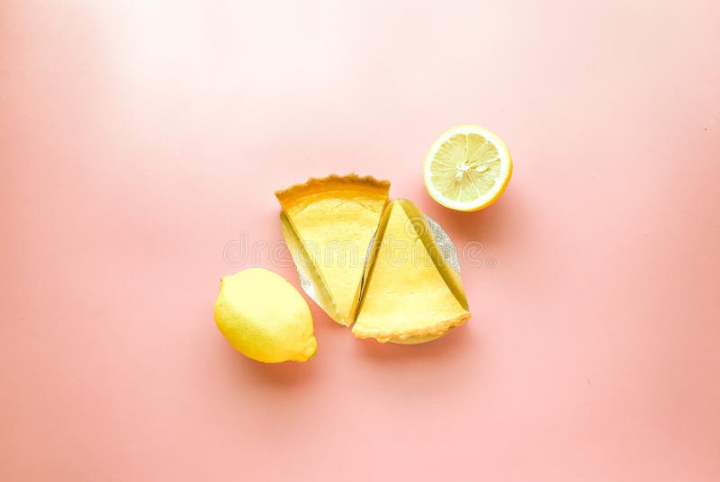Two Pieces of Lemon Pies with Whole and Half Lemon Fruit on Pink ...