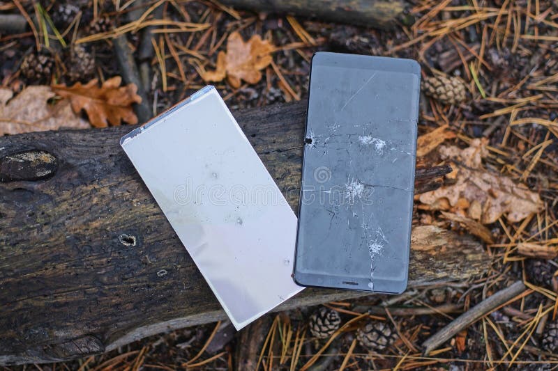 Two Pieces of an Old Disassembled Smartphone with a Broken Black Screen ...