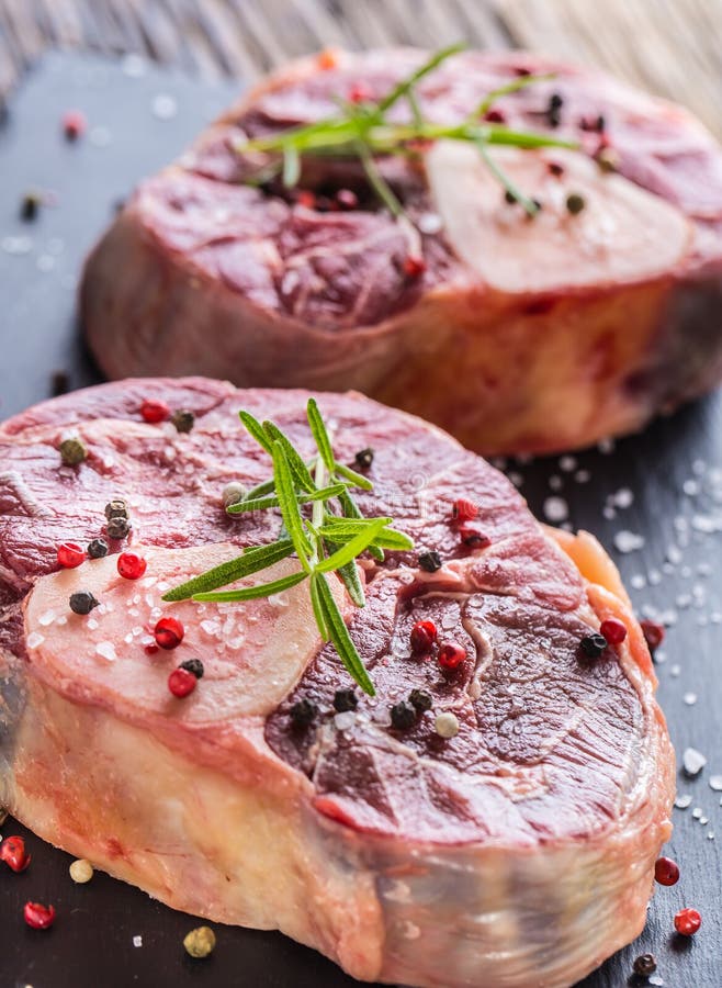 Two Pieces Raw Beef Shank on Slate Board and Wooden Table. Stock Photo ...