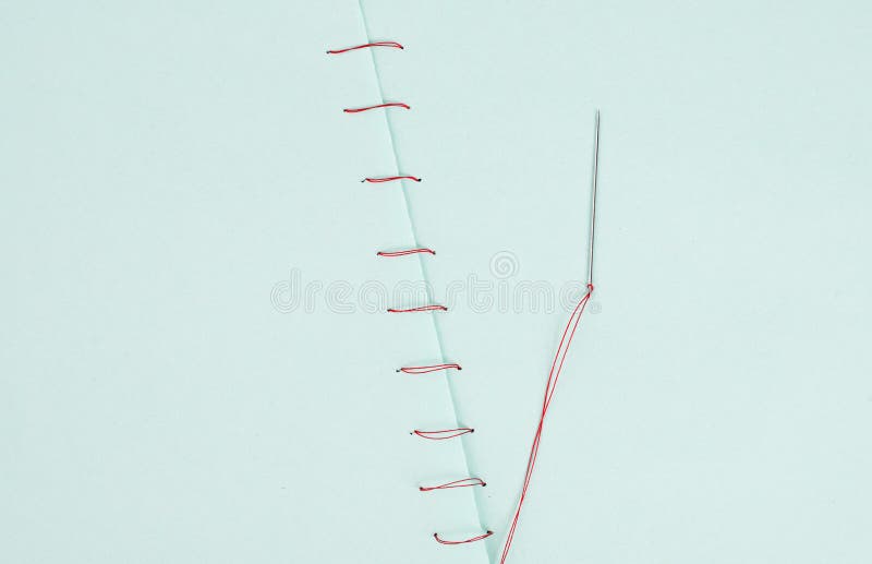 Two Pieces of Torn Paper Sewn Together with a Red String, Financial ...