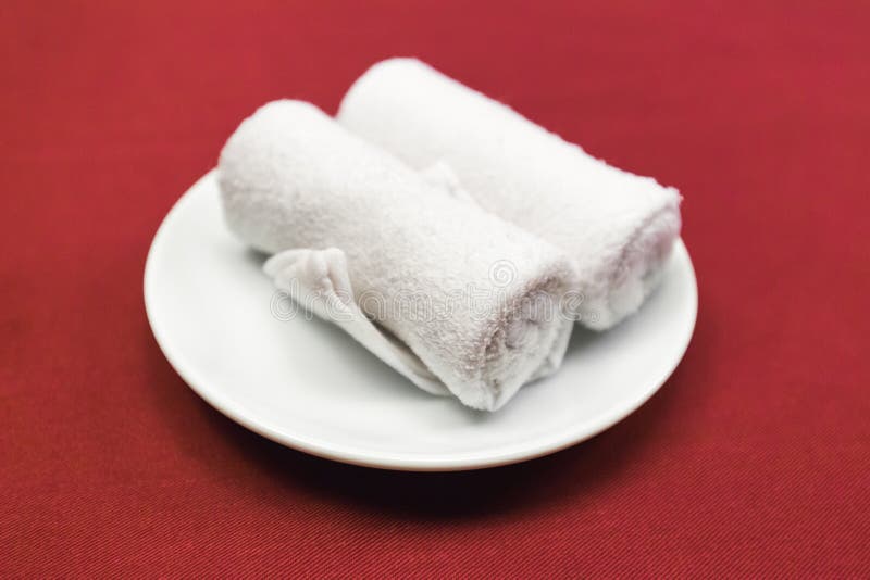 Two Pieces of White Rolled Napkin on White Dish Stock Photo - Image of ...