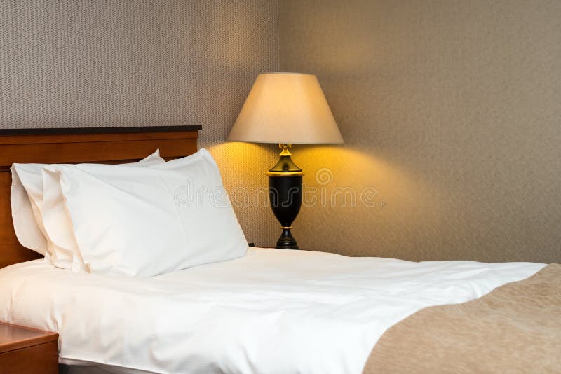 Two Pillows on Bed and Lamp on Wooden Table Stock Photo - Image of room ...