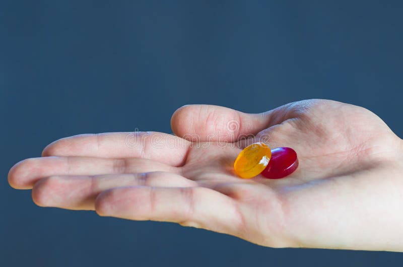 Two Pills Red and Yellow on the Palm in the Hand Medicine Stock Photo ...