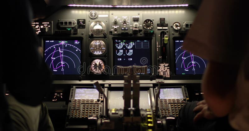 Two Pilots are in the Cockpit. Aircraft Control. Twilight. Close-up of ...