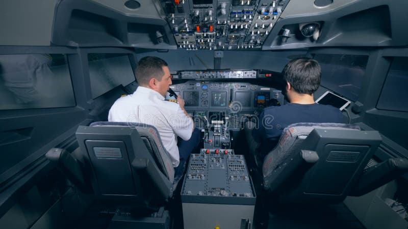 Two Pilots Sit in the Cockpit. Stock Video - Video of airplane, cockpit ...