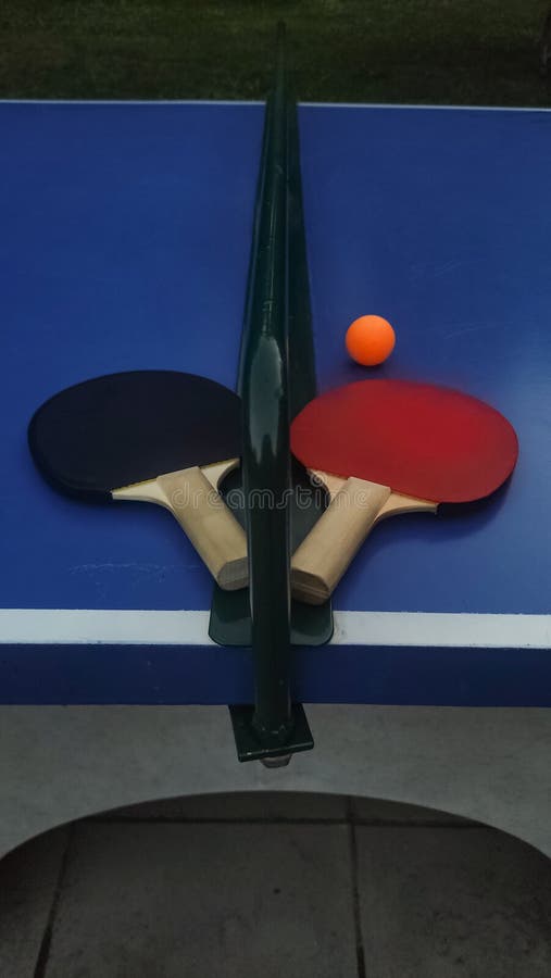 Two Ping Pong Paddles are Resting on the Table Next To a Ball Stock ...