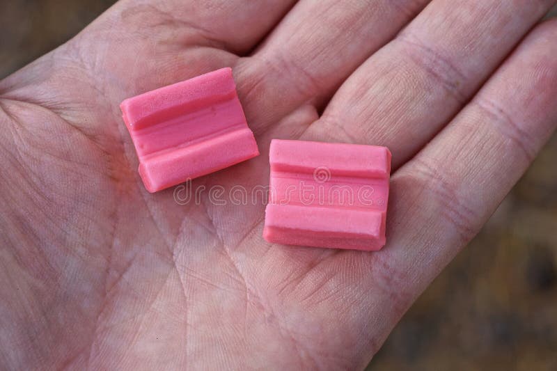 Two Pink Chewing Gum Candies Lie on the Palm Stock Photo - Image of ...