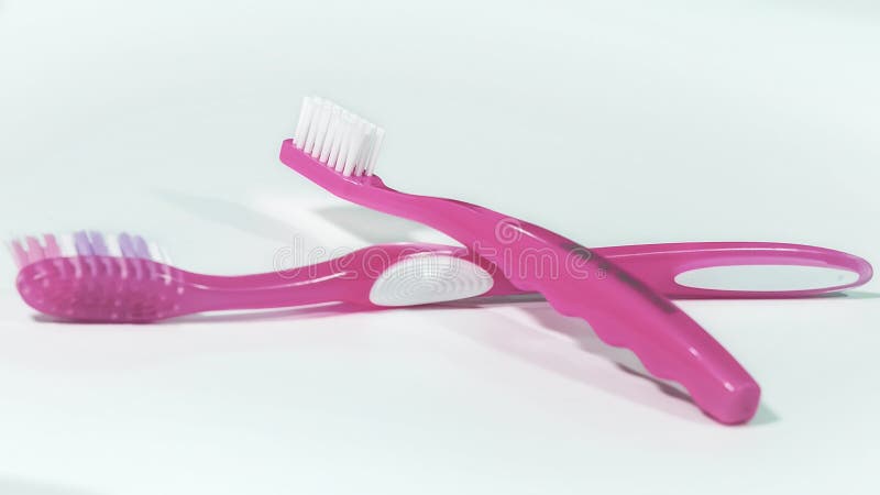 Two Pink Toothbrushes on a Light Background Stock Photo - Image of ...