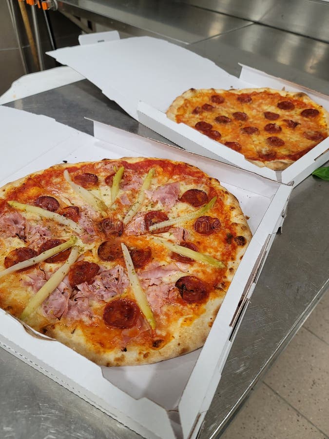Two Pizzas in Boxes Sitting on a Counter with Handles Stock Image ...