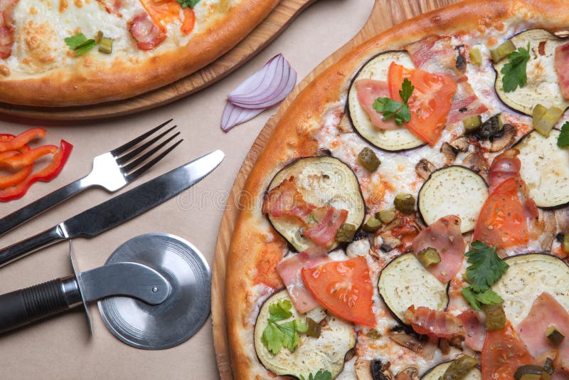Two Pizzas Next To Them and Fork and Knife Stock Photo - Image of fresh ...