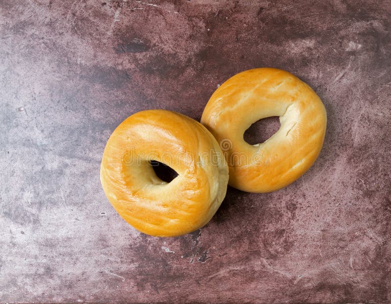Two Plain Bagels on a Red Mottled Countertop Top View Stock Photo ...