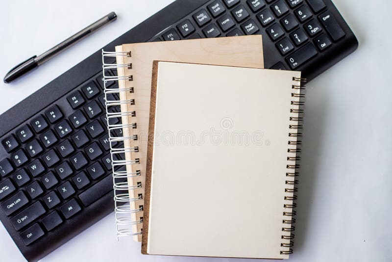 Two Plain Lined Spiral Notebooks with Pen and Keyboard on Table. Simple ...