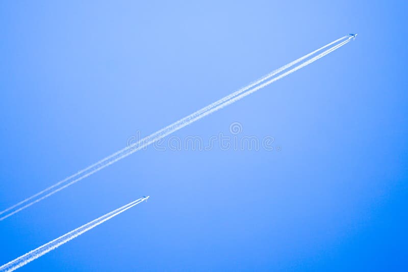 Two Planes Flying High in the Sky, Leaving White Streaks Stock Photo ...