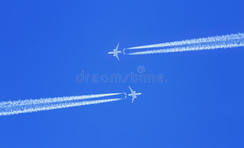 Two Planes Flying High in the Sky Meet, Leaving Streaks Stock Photo ...
