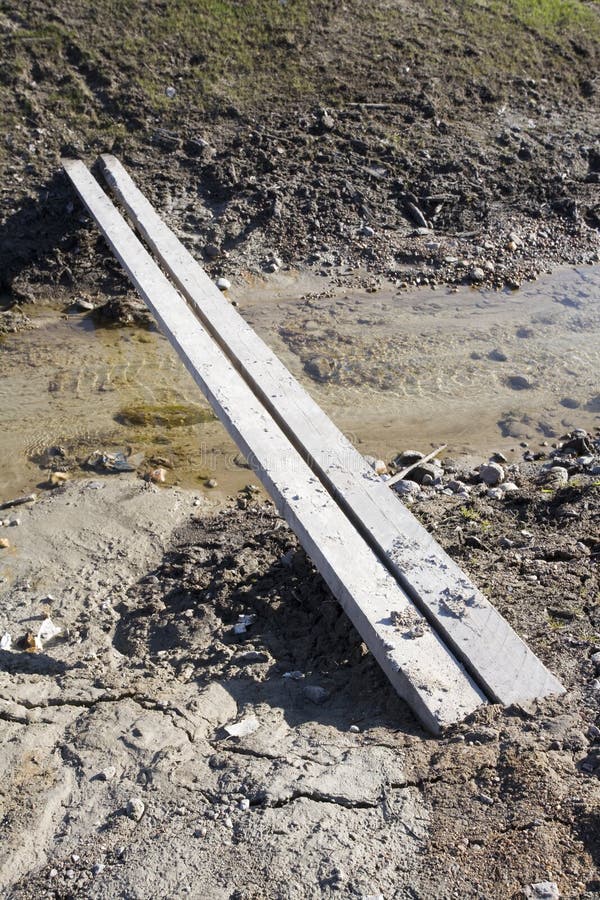 Two Planks Crossing Over a Ditch Stock Image - Image of muddy, soil ...