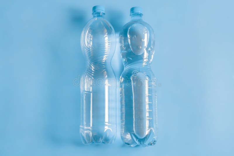 Two Plastic Bottles on a Blue Background. Stock Image - Image of glass ...
