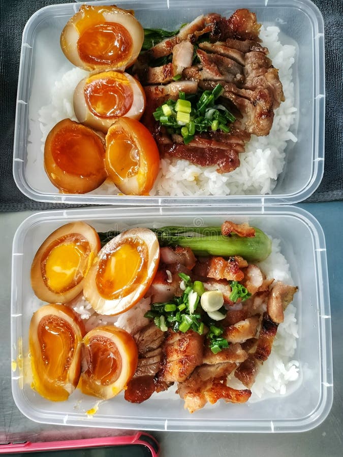 Two Plastic Containers Filled with Food on Top of a Table. Stock Photo ...